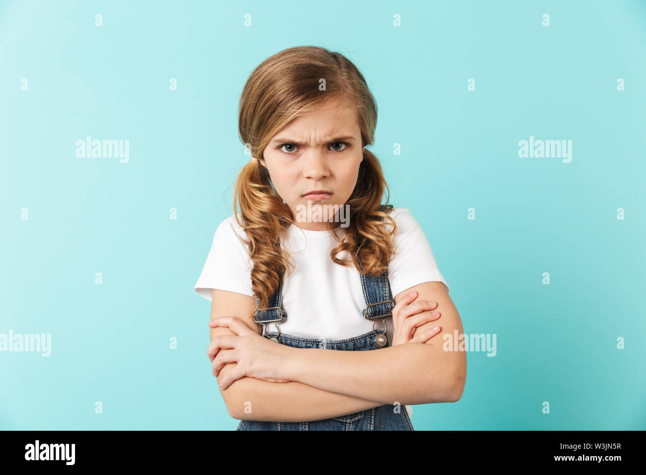 Image of pretty confused displeased young little girl posing isolated ...