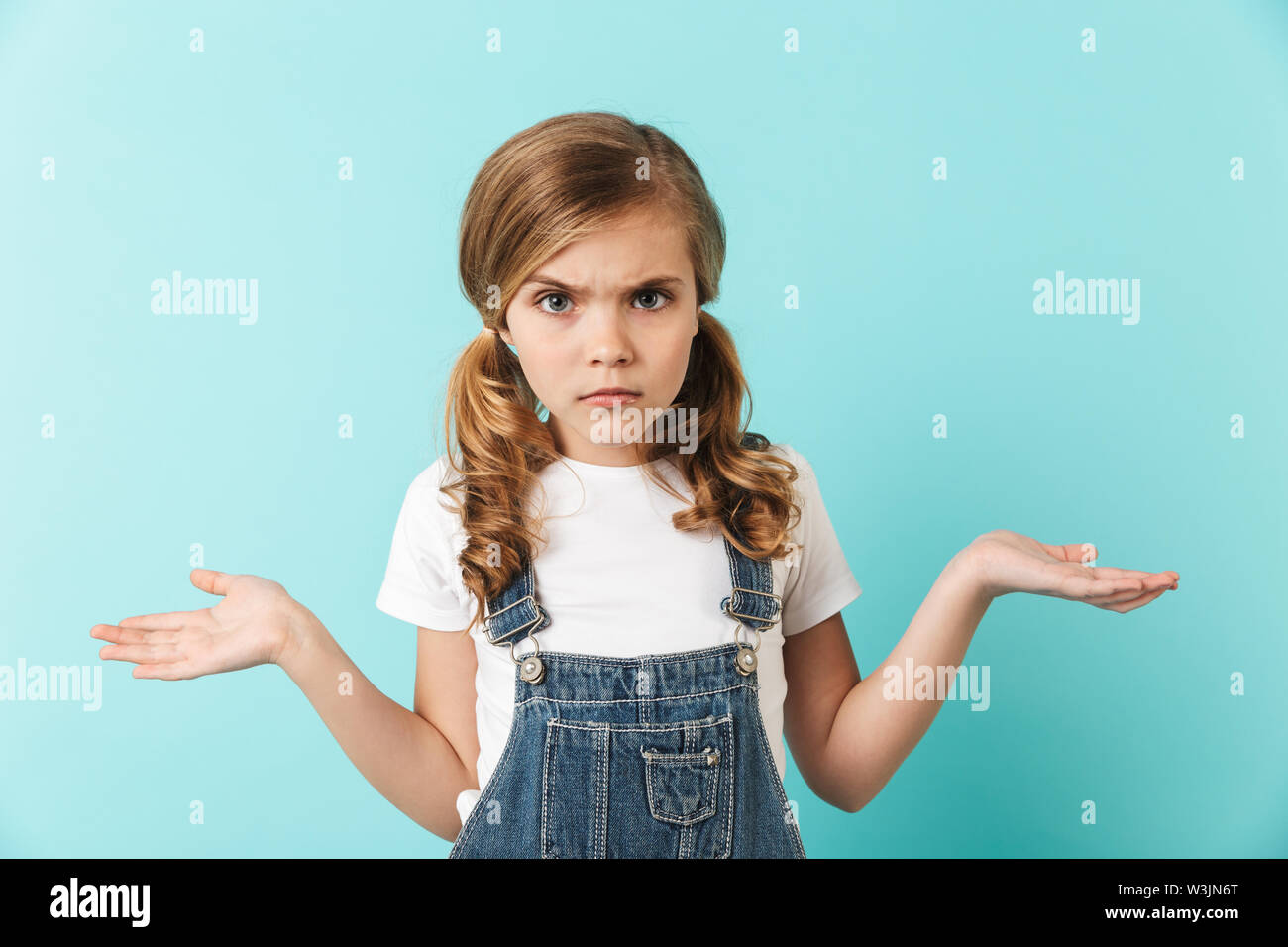Image of pretty confused displeased young little girl posing isolated ...