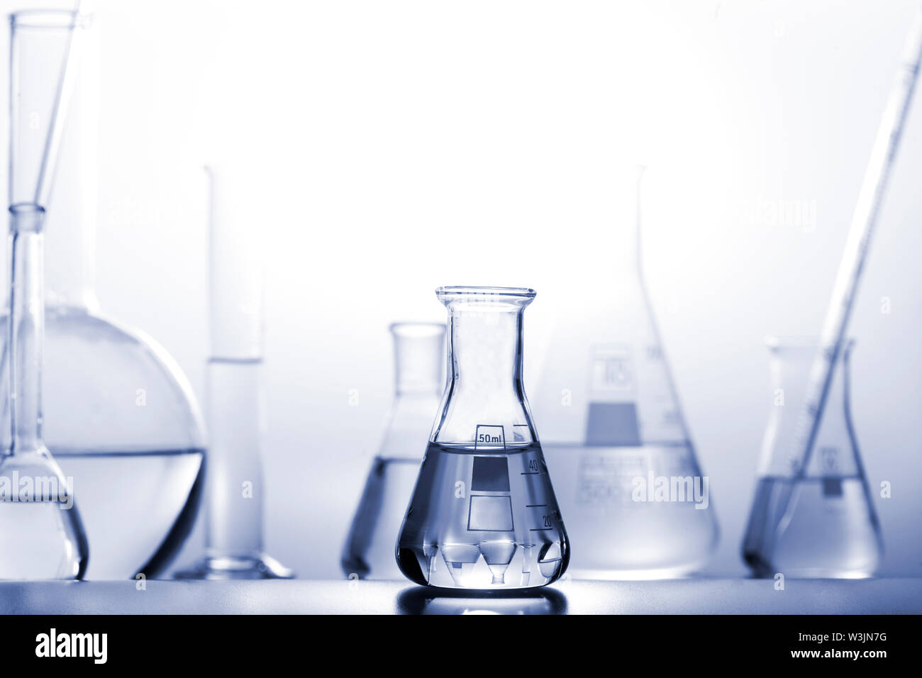 Test-tubes with reflections on a white and blue background. Laboratory ...