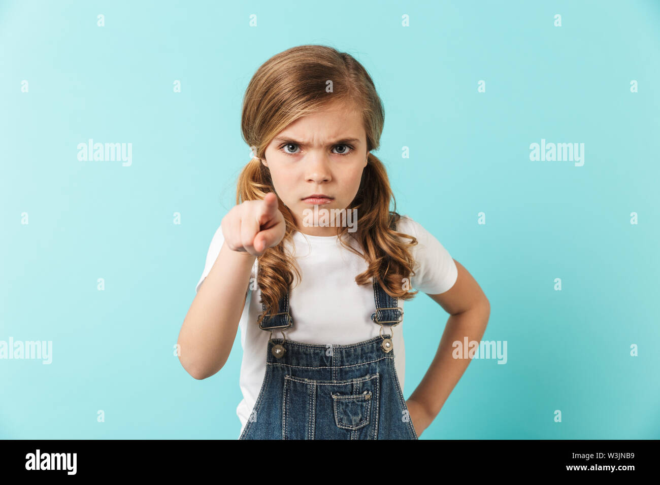 Image of pretty confused displeased young little girl posing isolated ...