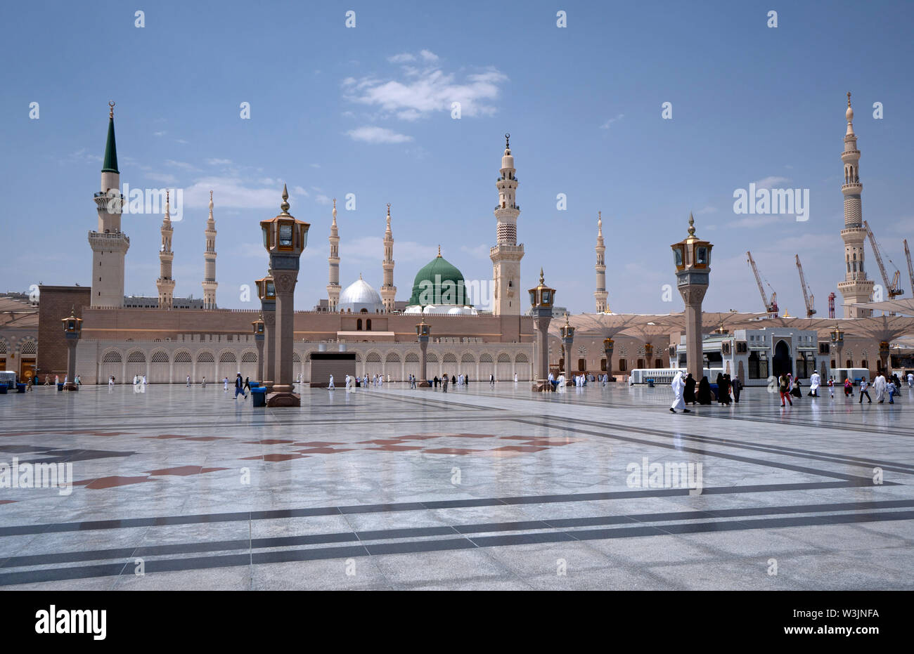 MEDINA, SAUDI ARABIA - JUNE 25: Muslims marching in front of the mosque ...