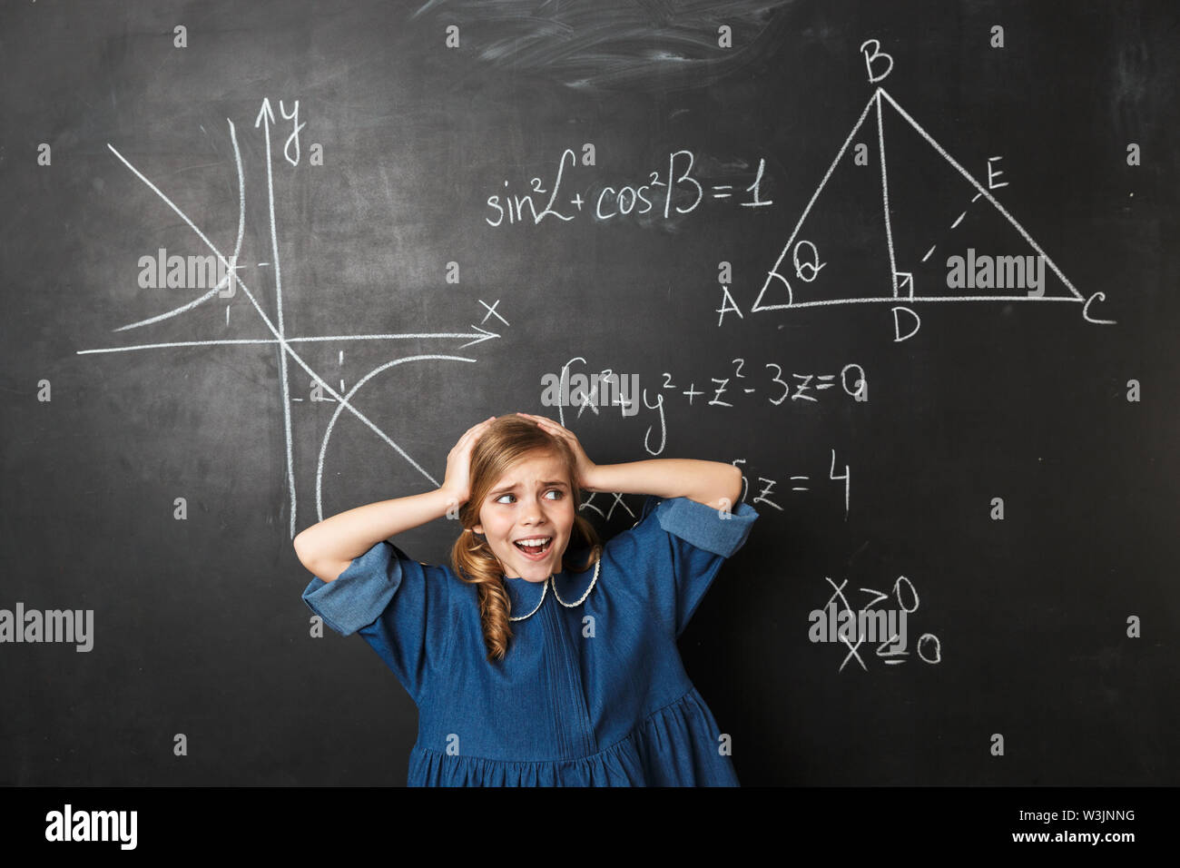 Image of pretty shocked confused young little school girl posing ...