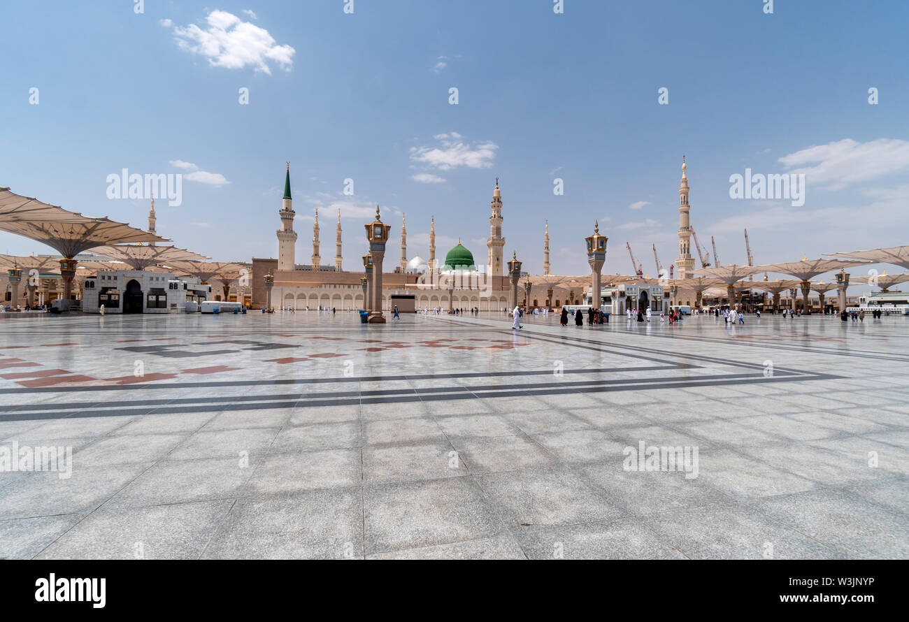 MEDINA, SAUDI ARABIA - JUNE 25: Muslims marching in front of the mosque ...
