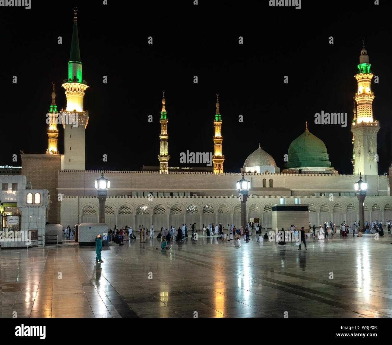 MEDINA, SAUDI ARABIA - JUNE 25: Muslims marching in front of the mosque ...