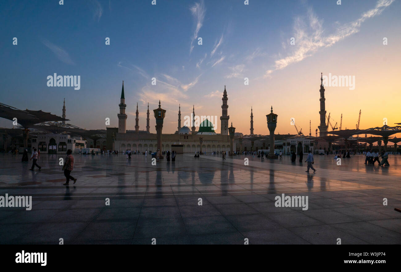 MEDINA, SAUDI ARABIA - JUNE 25: Muslims marching in front of the mosque ...