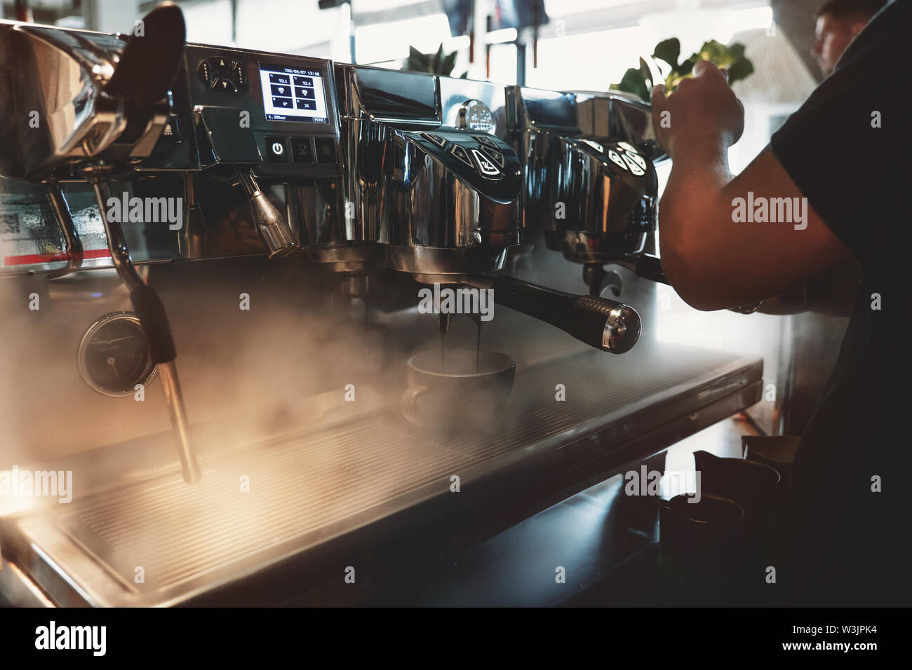 barista man making coffee drink using professional coffee machine ...