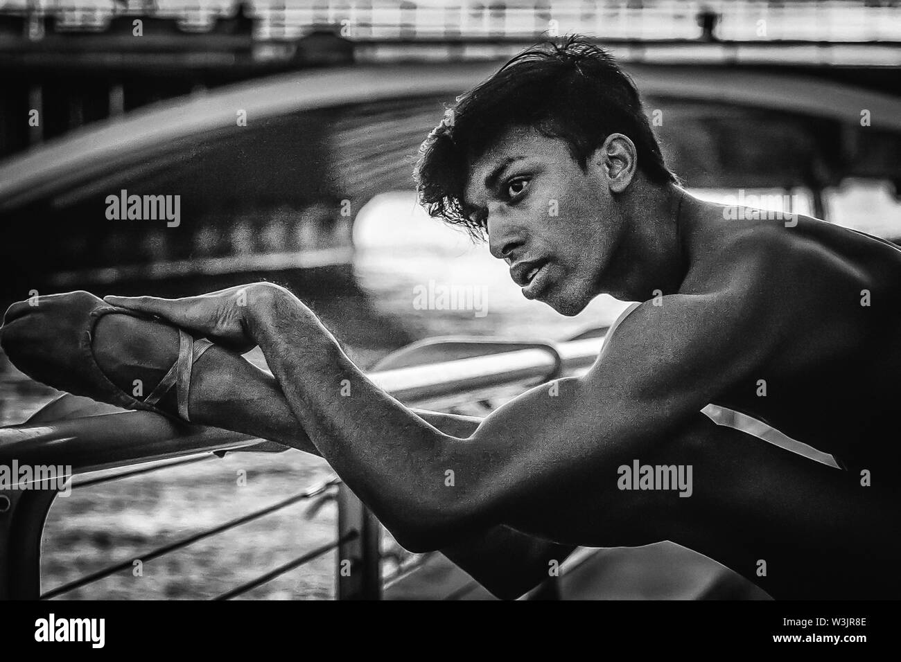 A male ballet dancer stretches by Chelsea Bridge in London, England ...