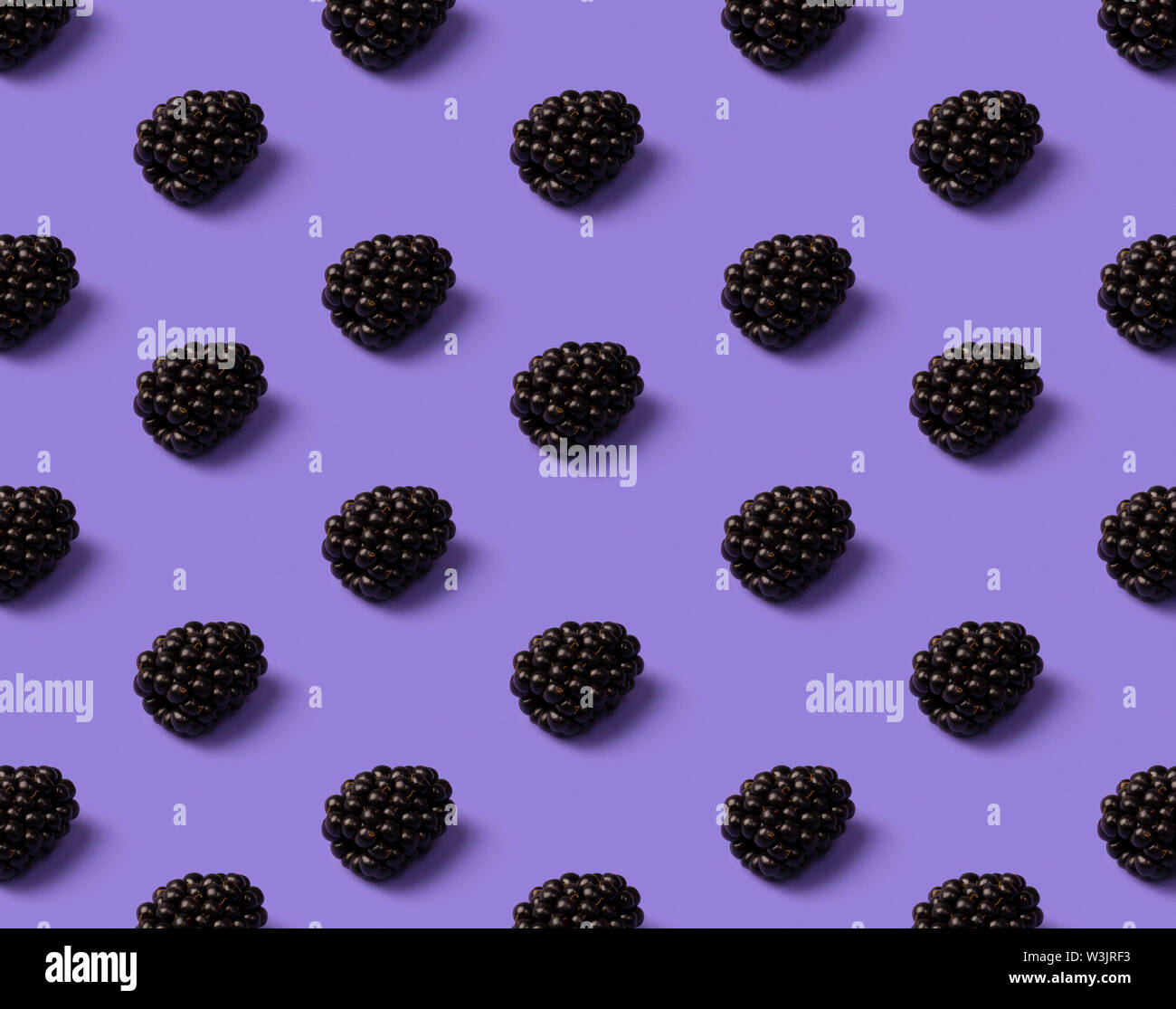 Blackberry pattern on a purple background. Top view Stock Photo - Alamy