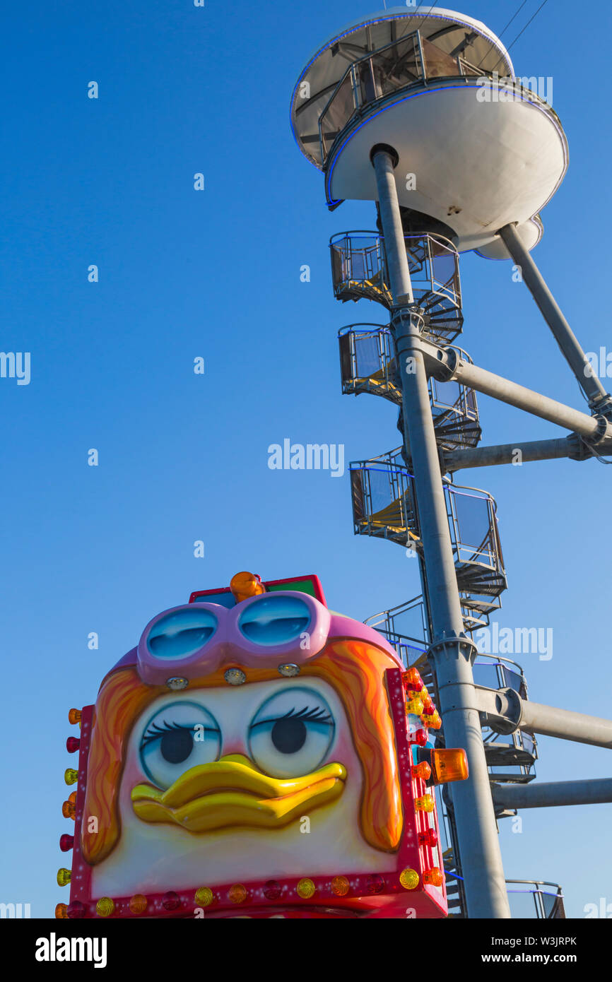 Fairground ride with zipwire launch tower towering behind on ...