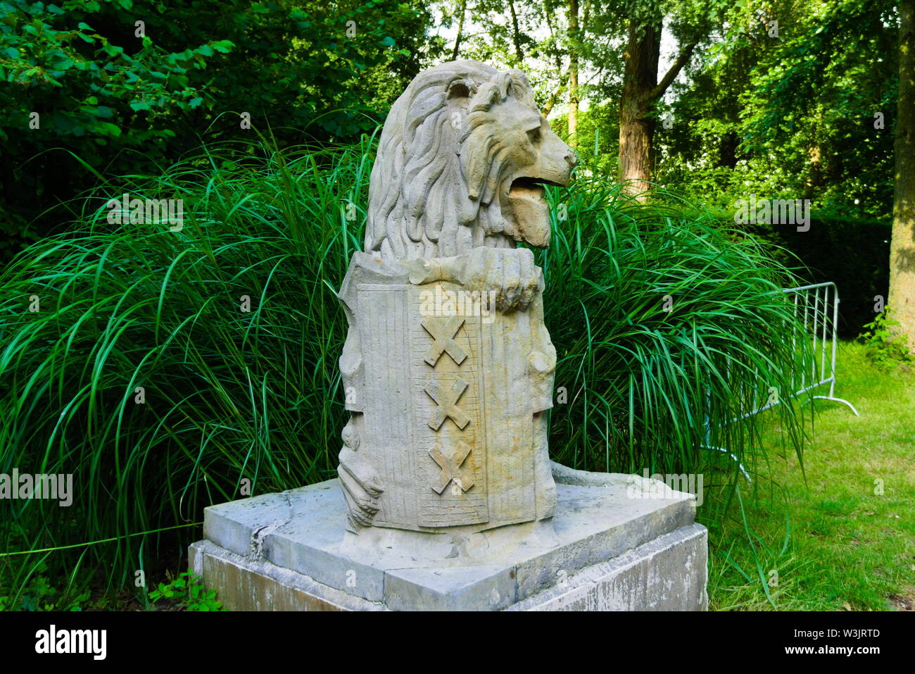 statue of a lion holding a shield with the flag of amsterdam Stock ...
