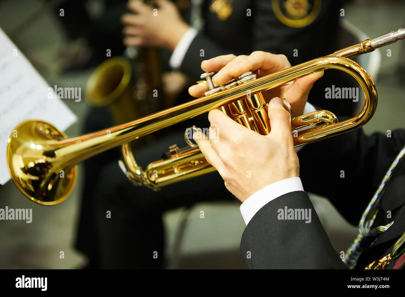 The trumpeter is playing on a silver trumpet. Trumpet players Stock ...