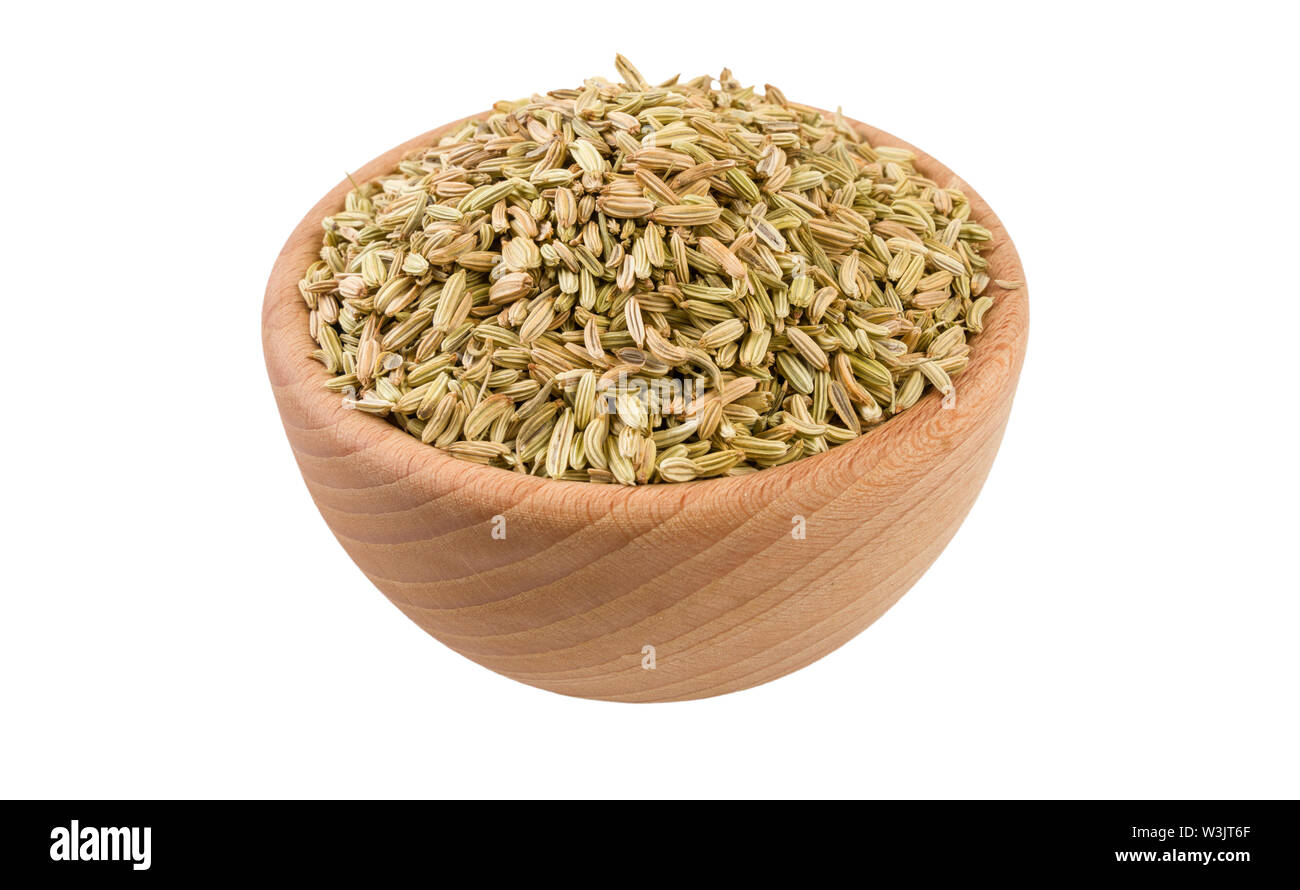 fennel seeds in wooden bowl isolated on white background. 45 degree ...