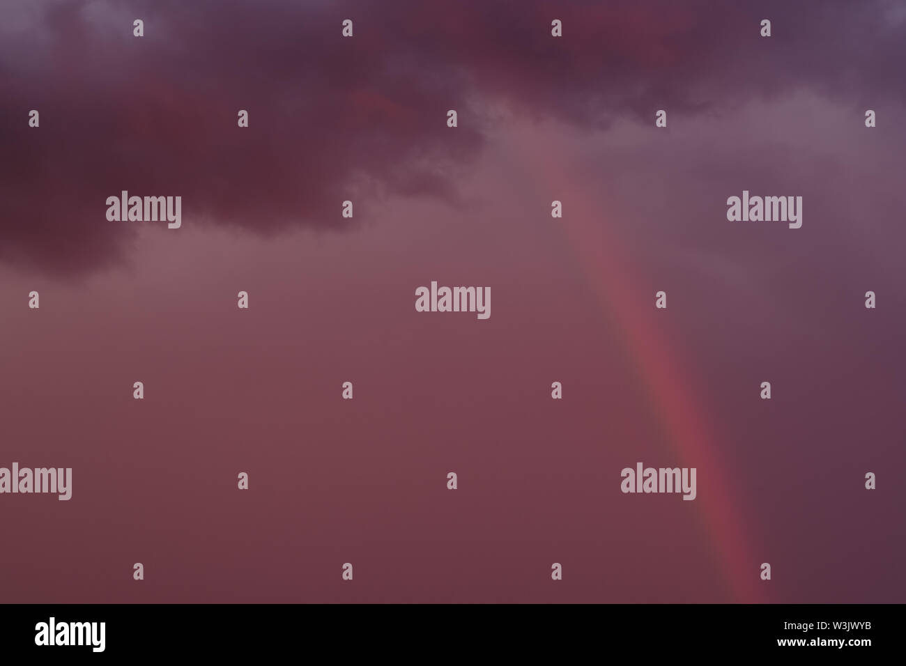 Full frame nature cloudy sky background with rainbow during rainy ...