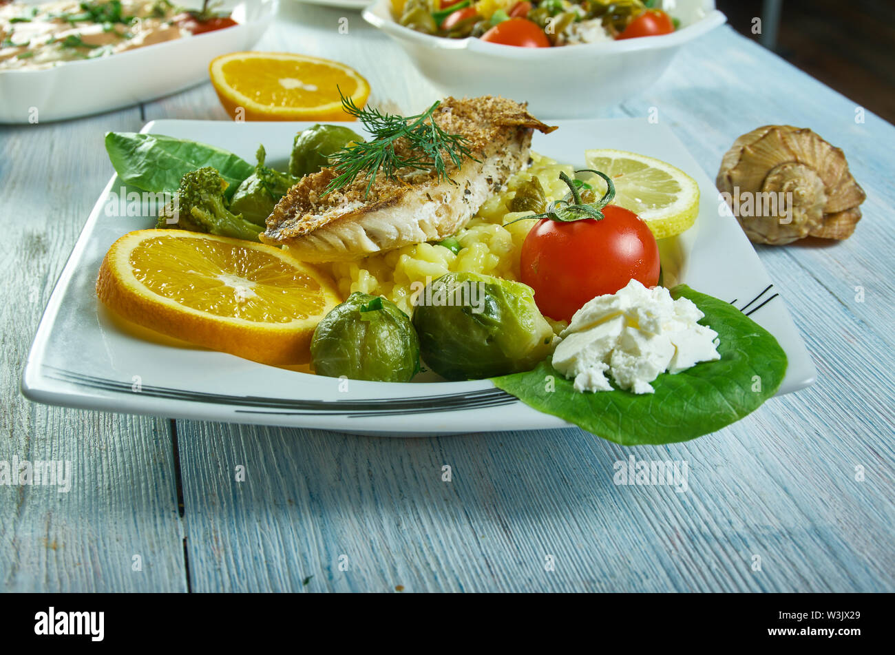 Crispy snapper with salsa verde risotto , Seafood risotto Stock Photo ...