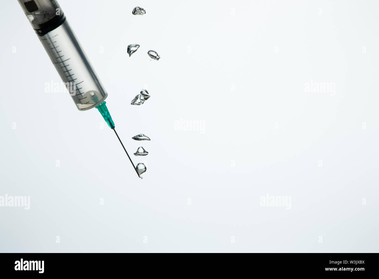 Close up of syringe with bubbles in water isolated on white with copy ...