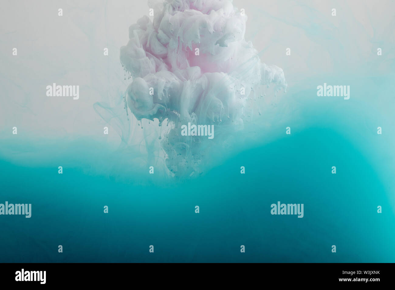 Close up view of white and turquoise smoky paint isolated on grey Stock ...