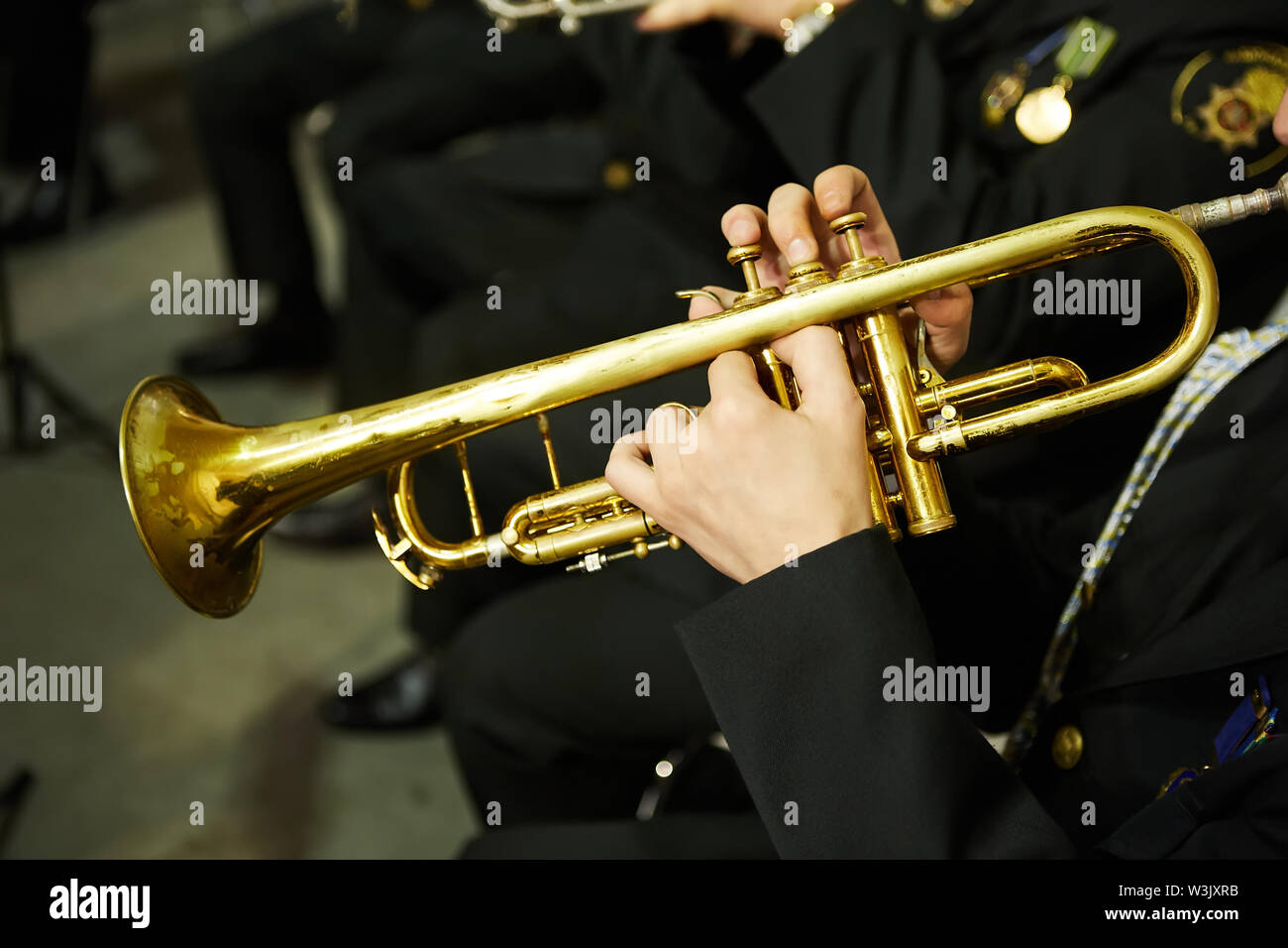 The trumpeter is playing on a silver trumpet. Trumpet players Stock ...