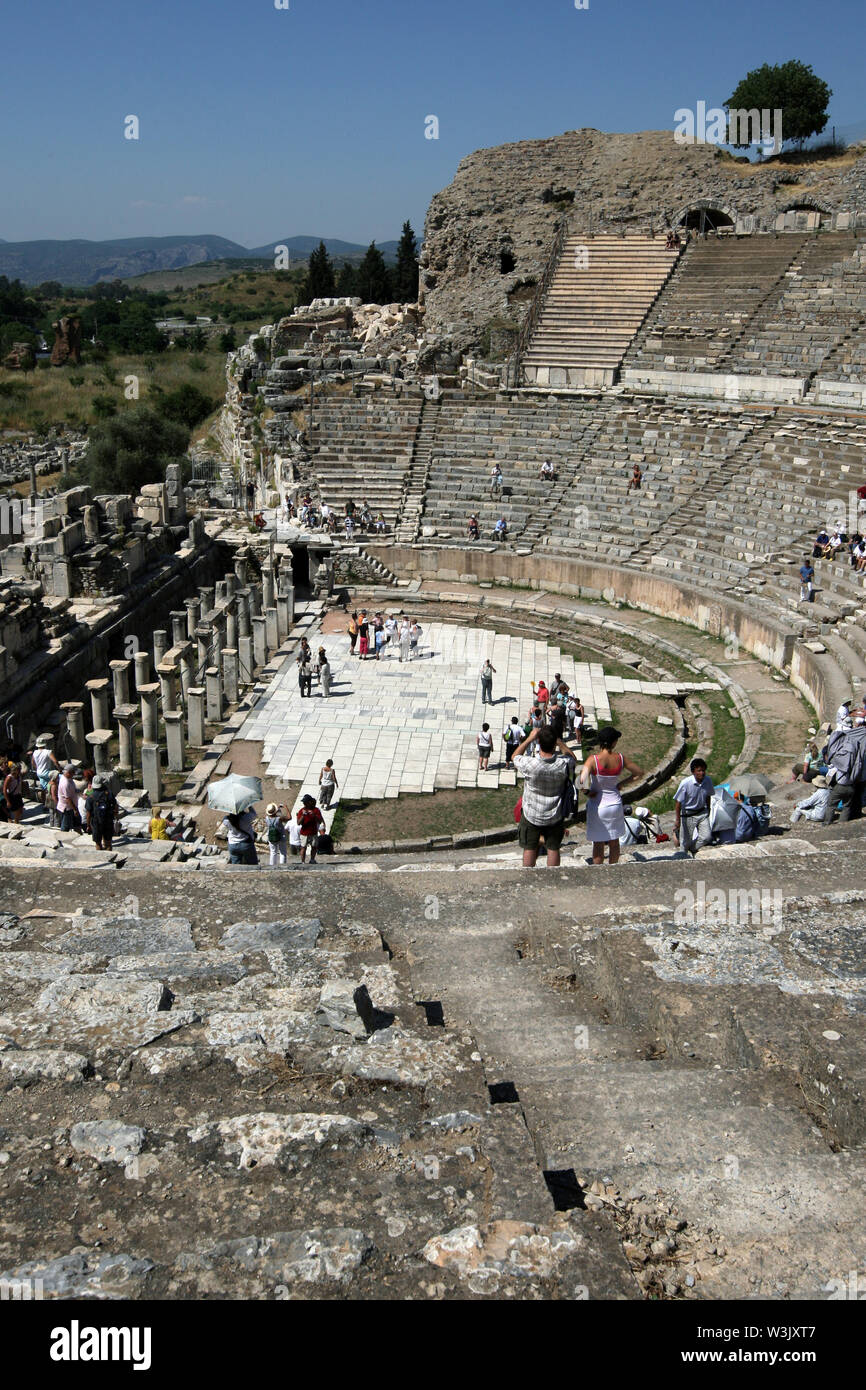 People gather amongst the Roman theatre ruins at the ancient site of ...