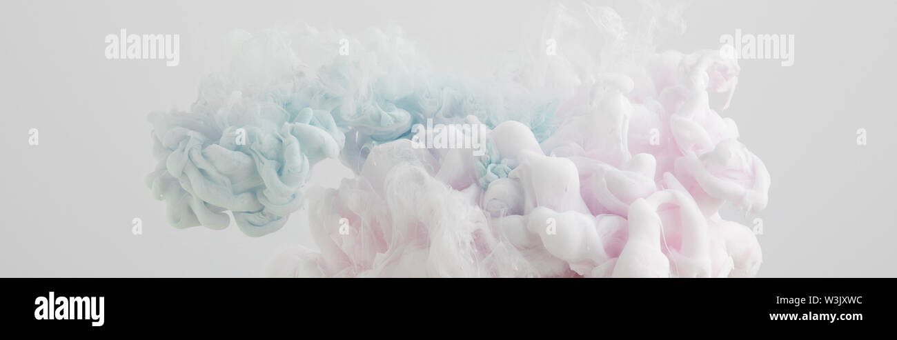 Close up view of light pink and light blue paint mixing isolated on ...