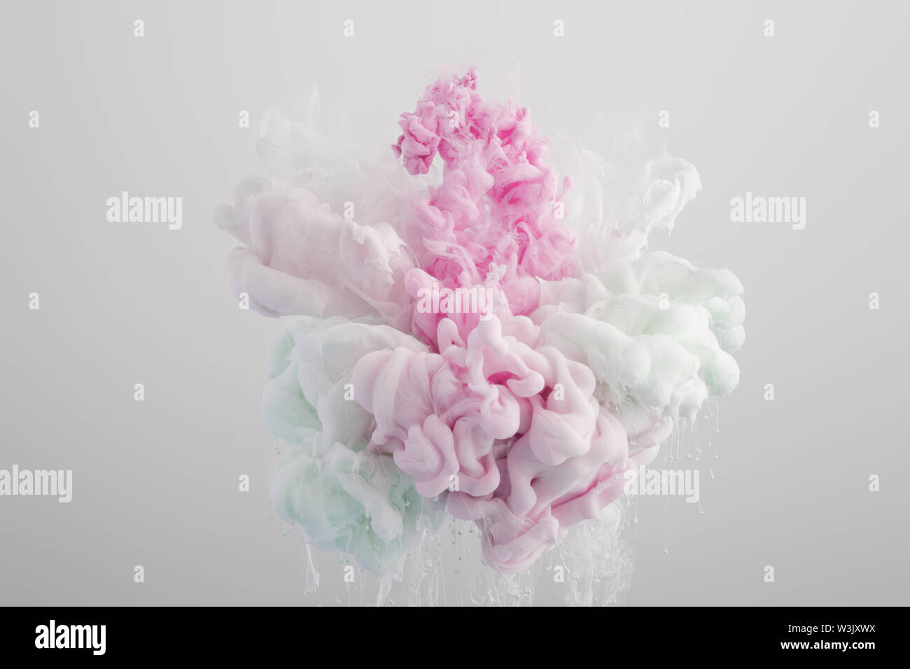 Close up view of blue, white and pink paint splash isolated on grey ...