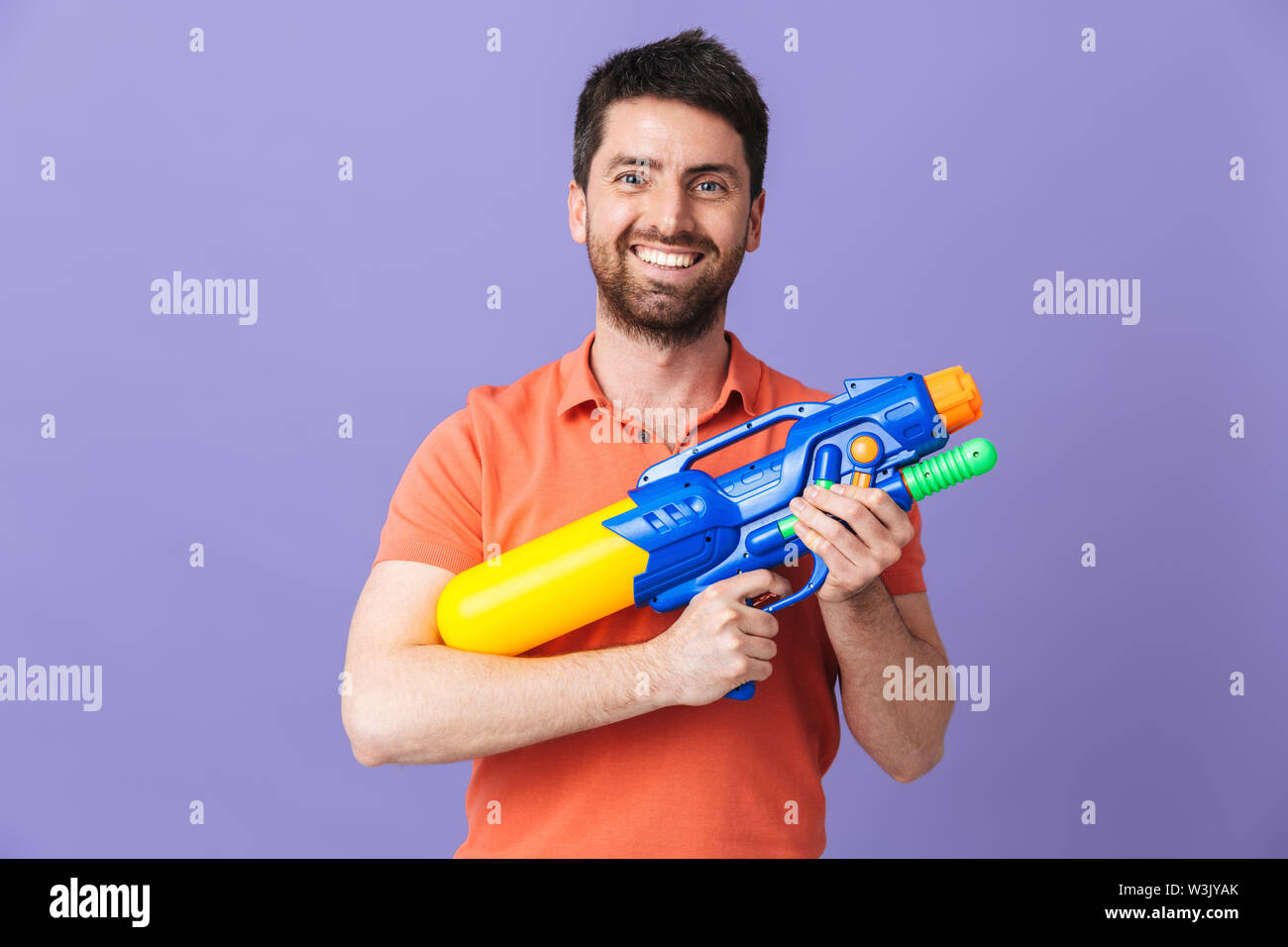 Image of a happy young handsome bearded man posing isolated over violet ...