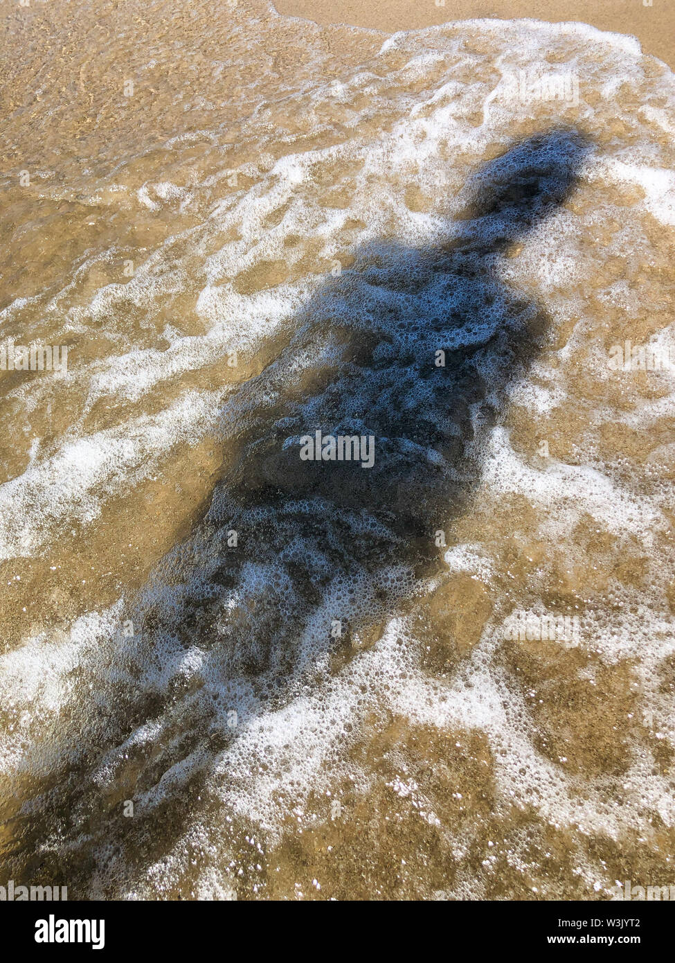 Young woman shadow on a sand Stock Photo - Alamy
