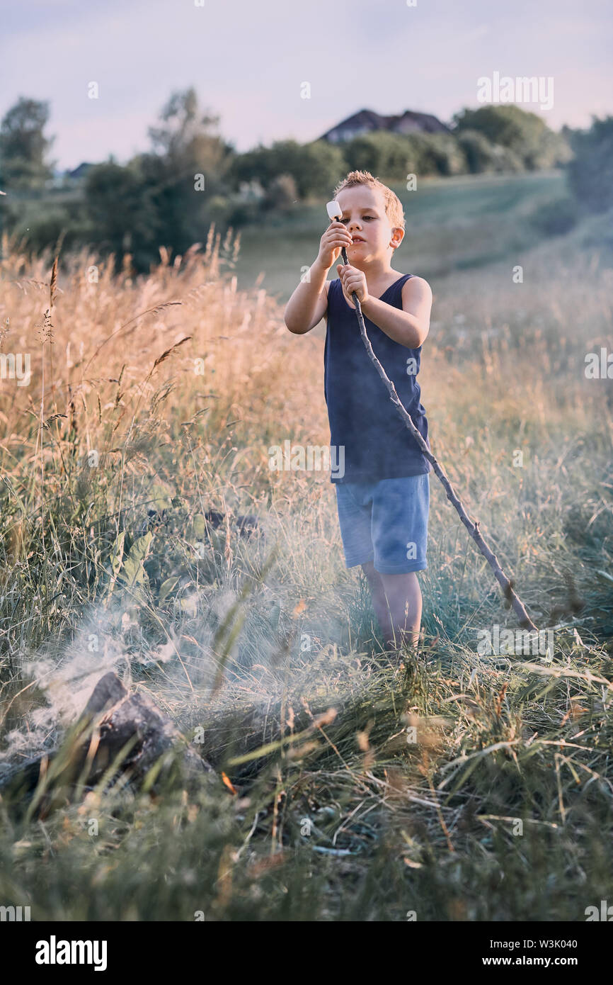 Father son roasting marshmallow over hi-res stock photography and ...