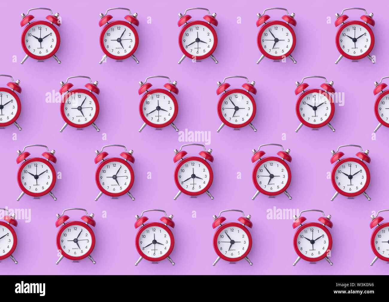 Classic red clock organized in a row over a purple background Stock ...