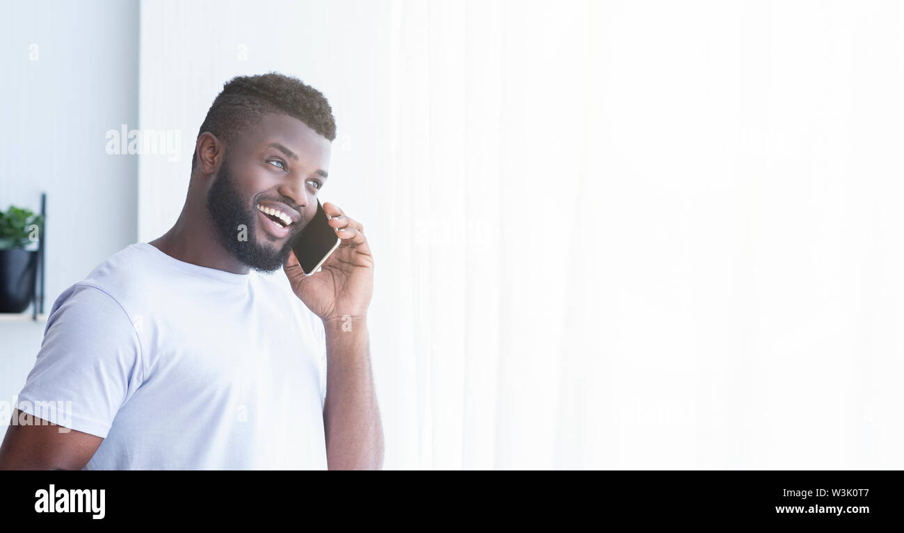 Cheerful young black businessman talking hi-res stock photography and ...