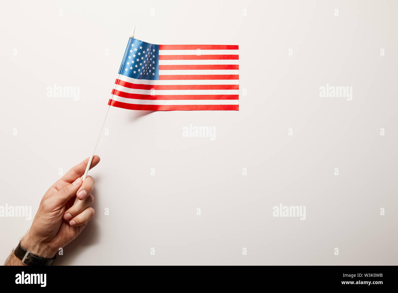 top view of man holding american flag on white background Stock Photo ...
