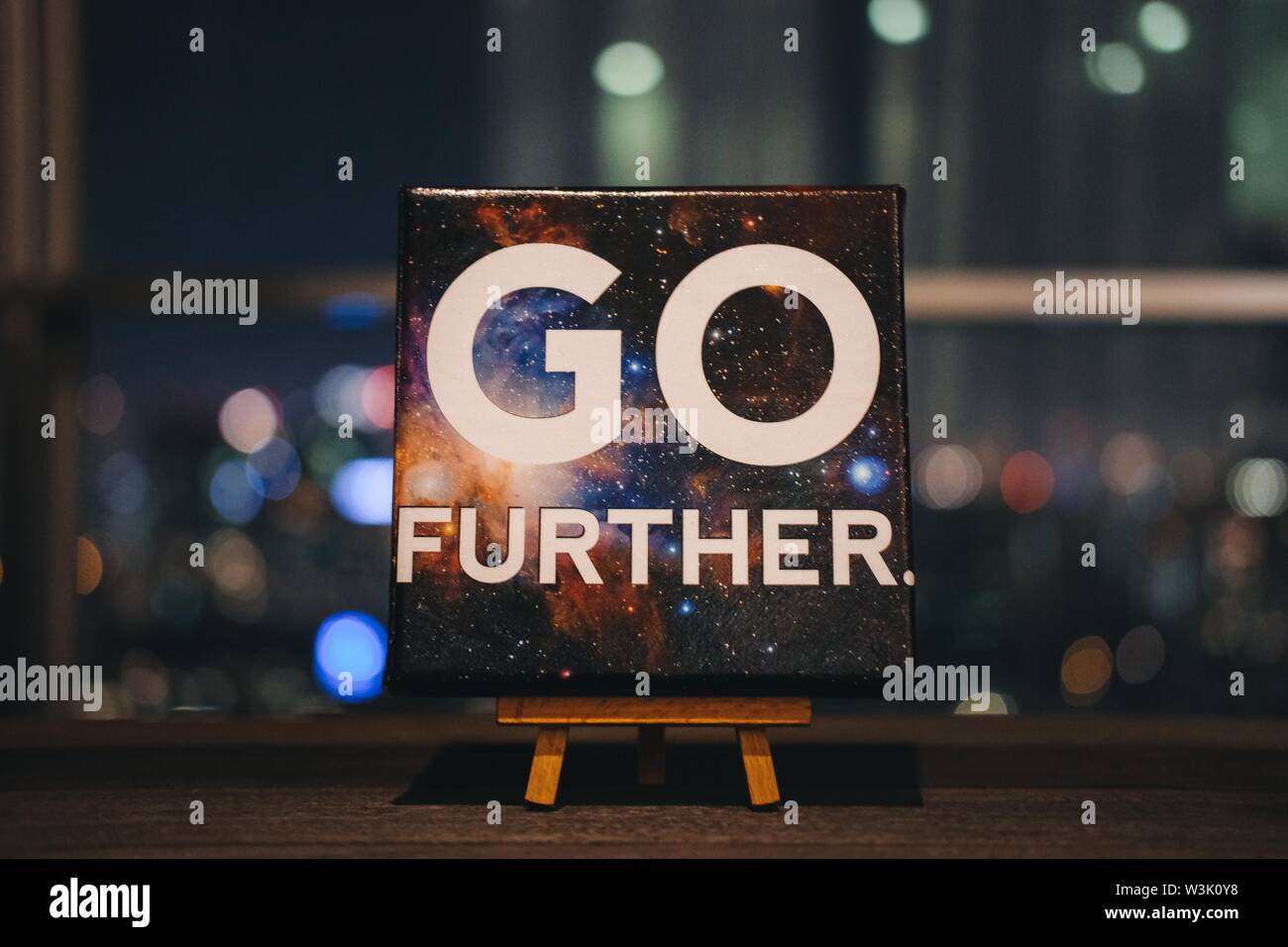 Typography on canvas space poster on top of easel "GO FURTHER Stock ...