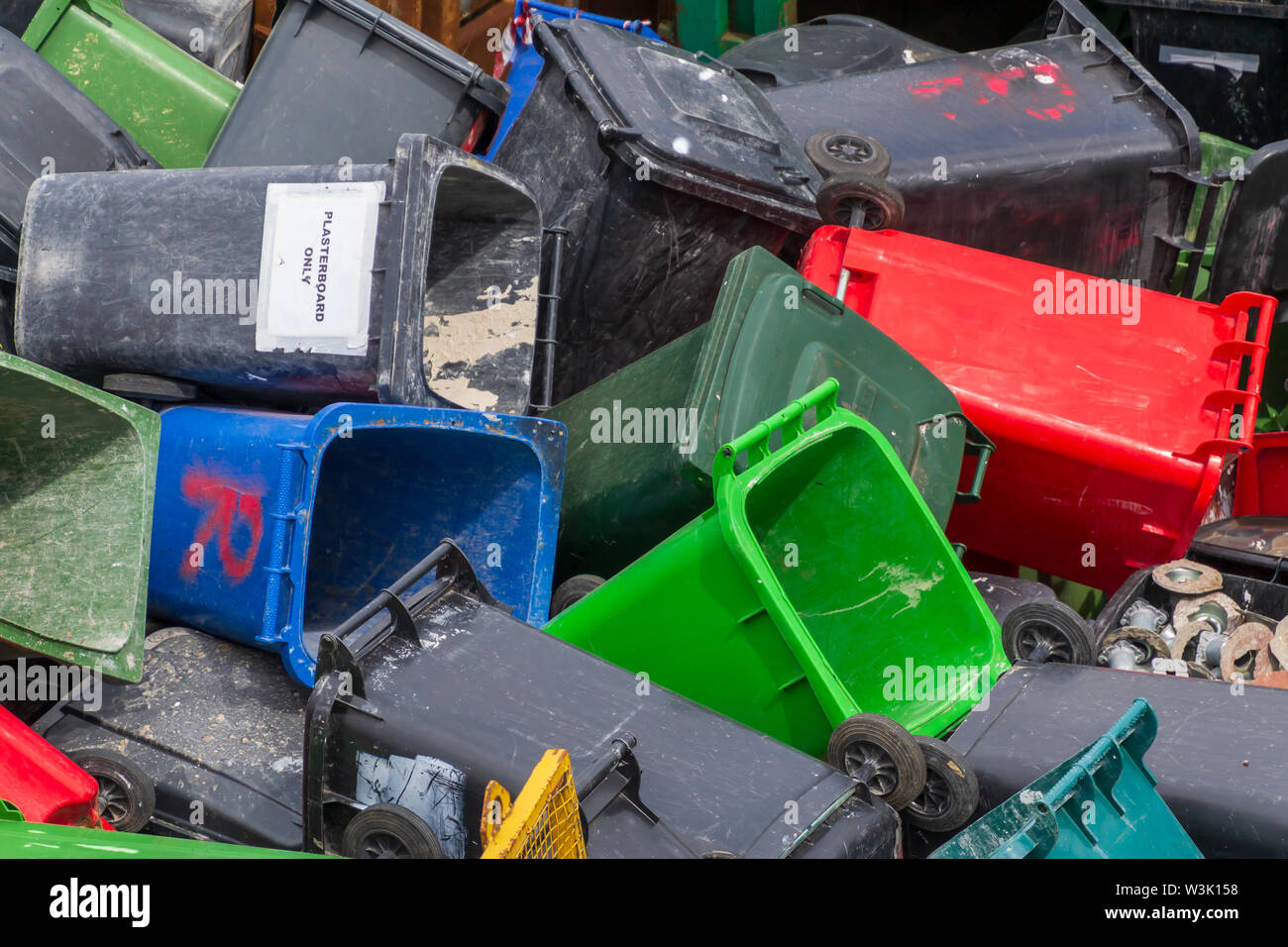 Colorful trash cans. Many plastic garbage cans on the waste waiting to ...