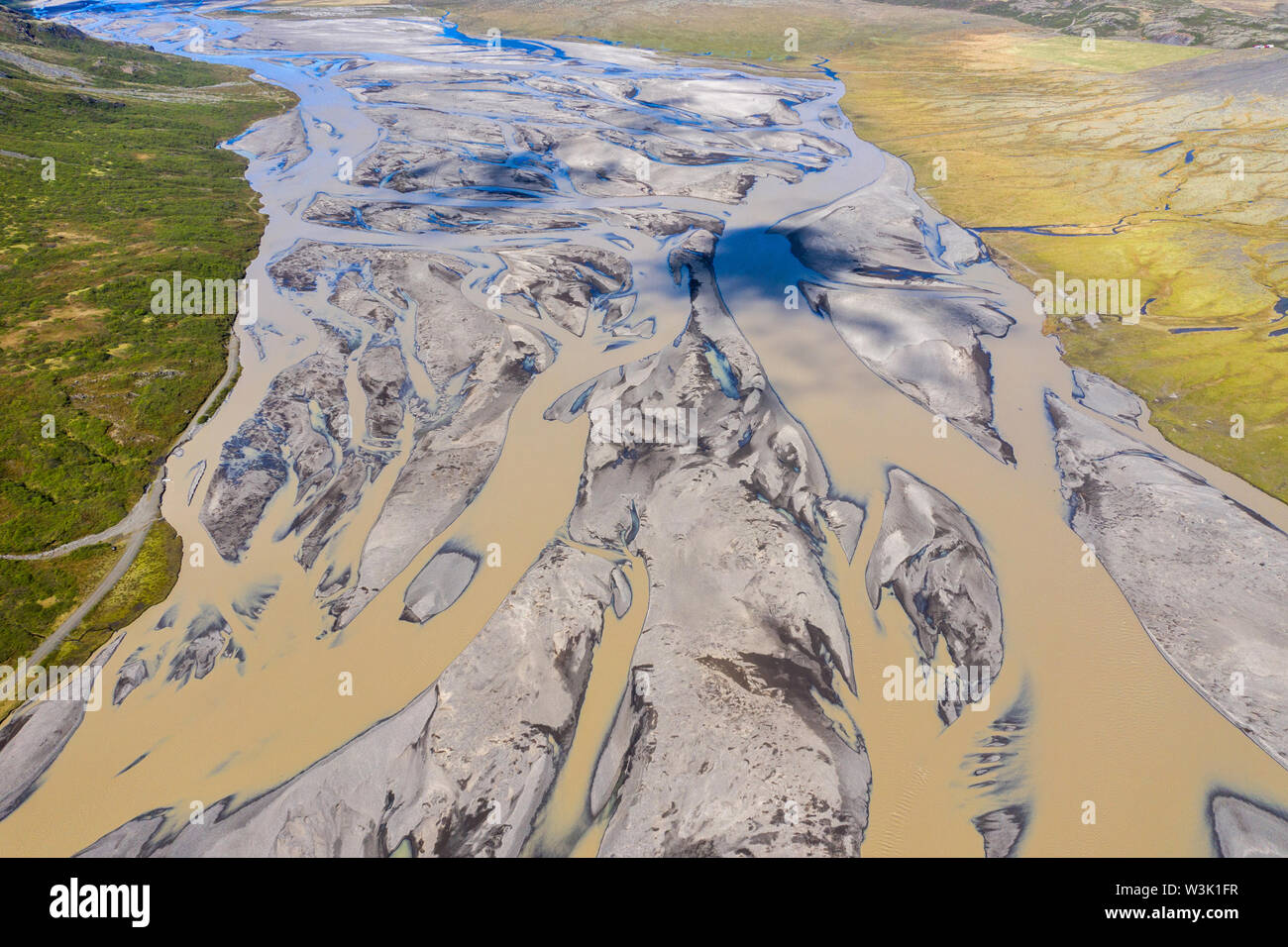 Aerial drone view of glacial river system transporting water from the ...