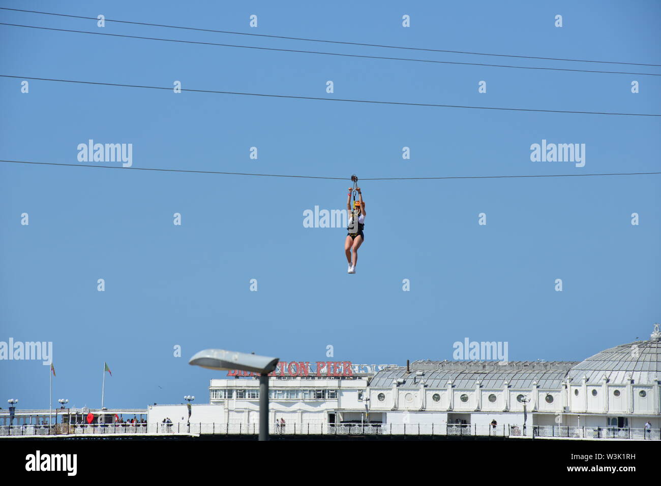 A lady zip wiring in Brighton Stock Photo - Alamy