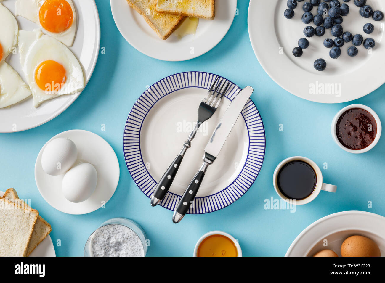 top view of table setting for breakfast on blue background Stock Photo ...