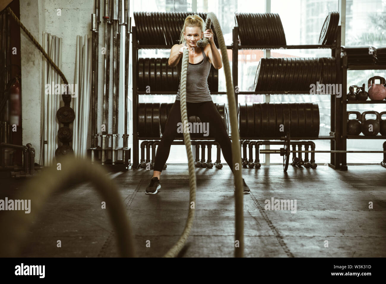 Beautiful young woman training at the gym Stock Photo - Alamy