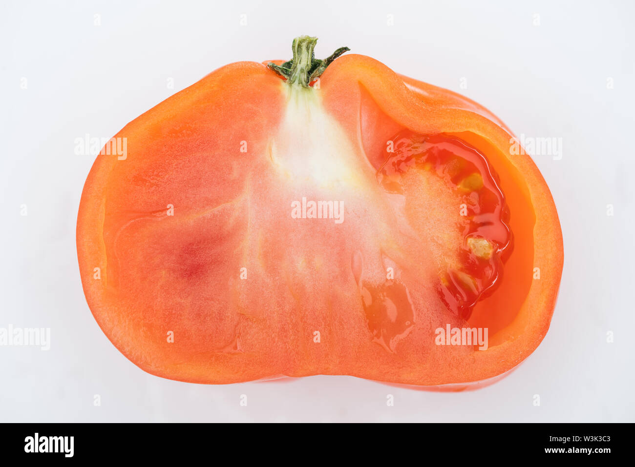 top view of red ripe tomato half with seeds isolated on white Stock ...