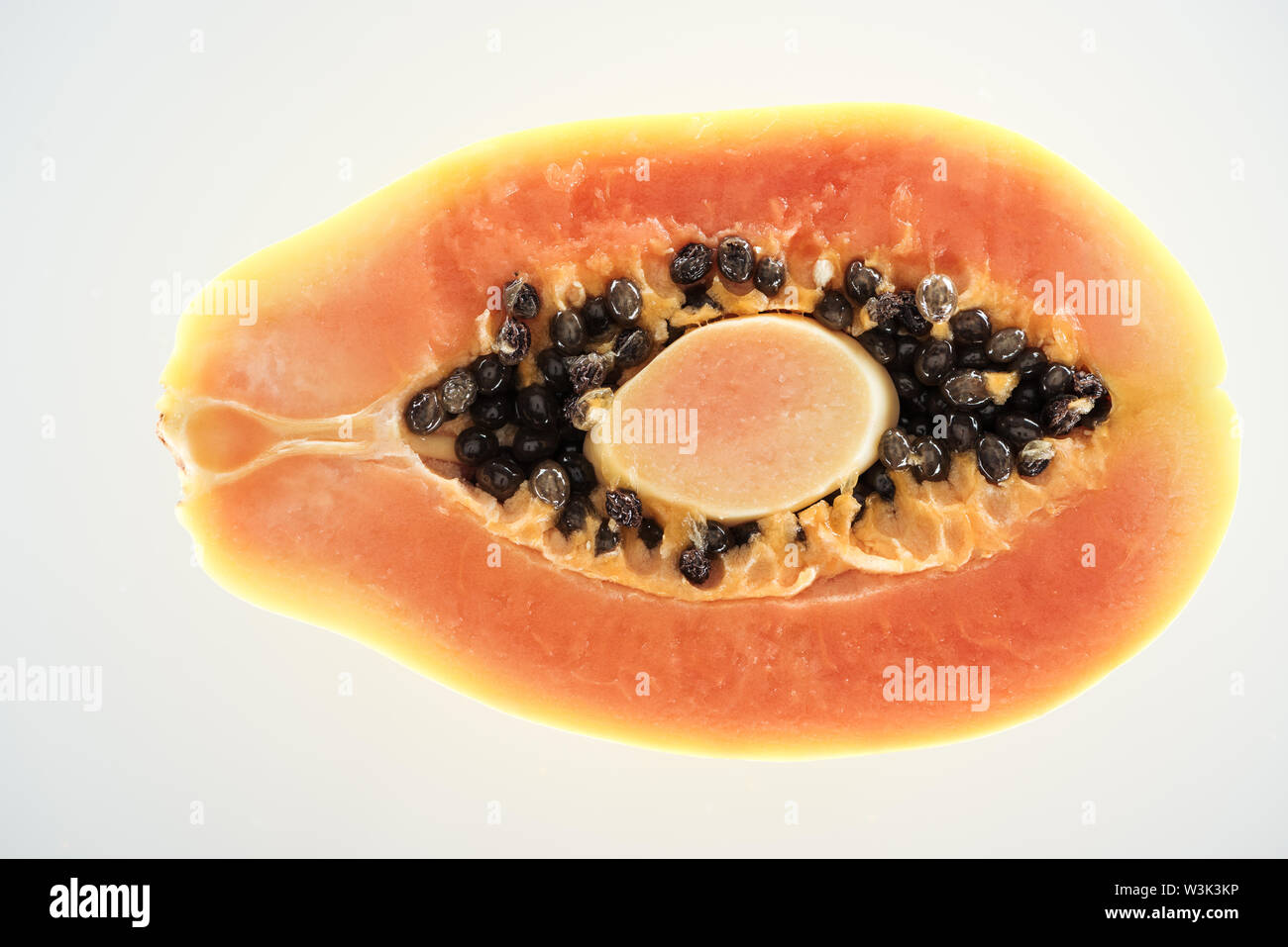 top view of ripe juicy papaya half with black seeds isolated on white ...