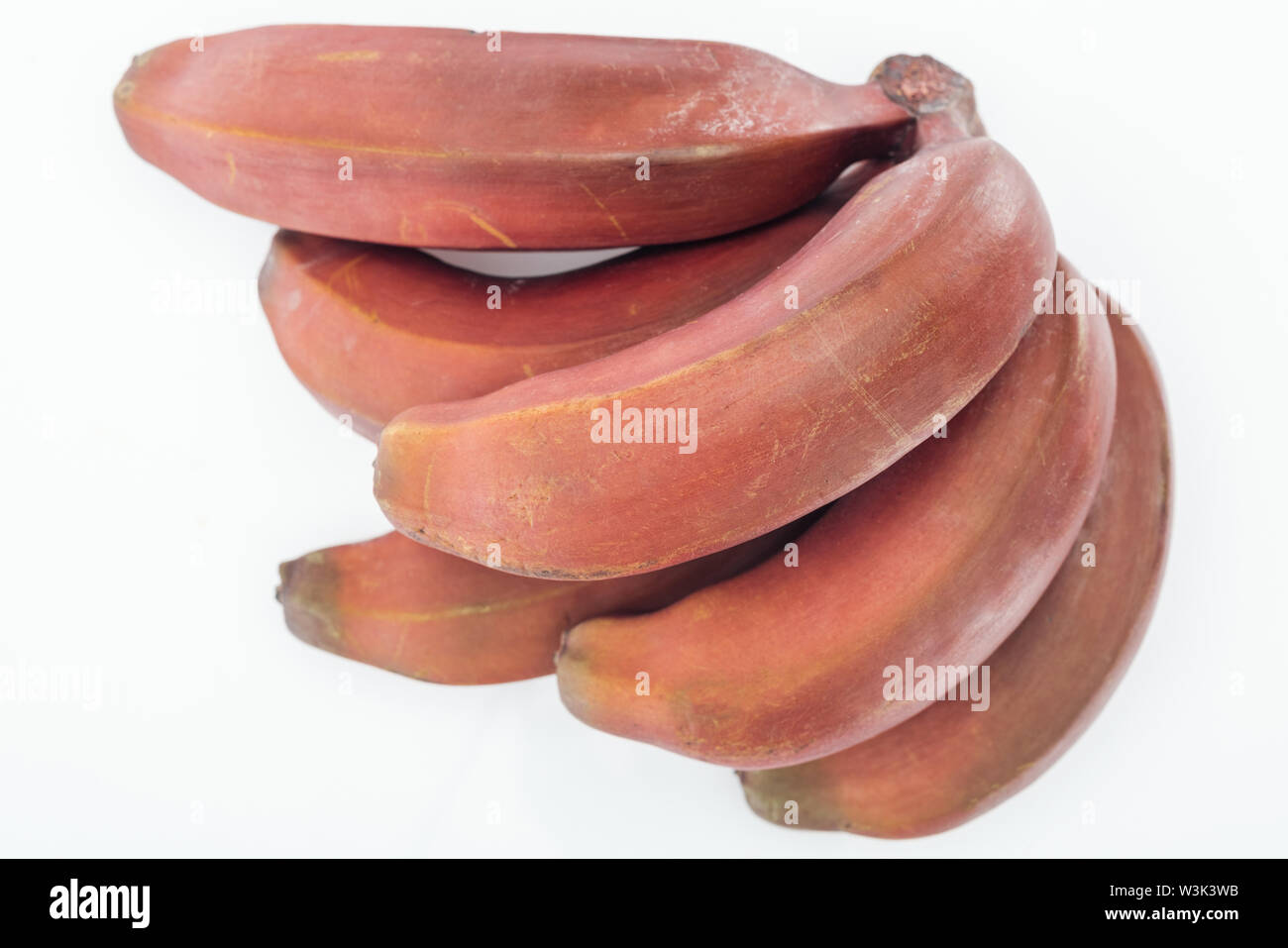 close up view of ripe tropical tasty red bananas isolated on white ...