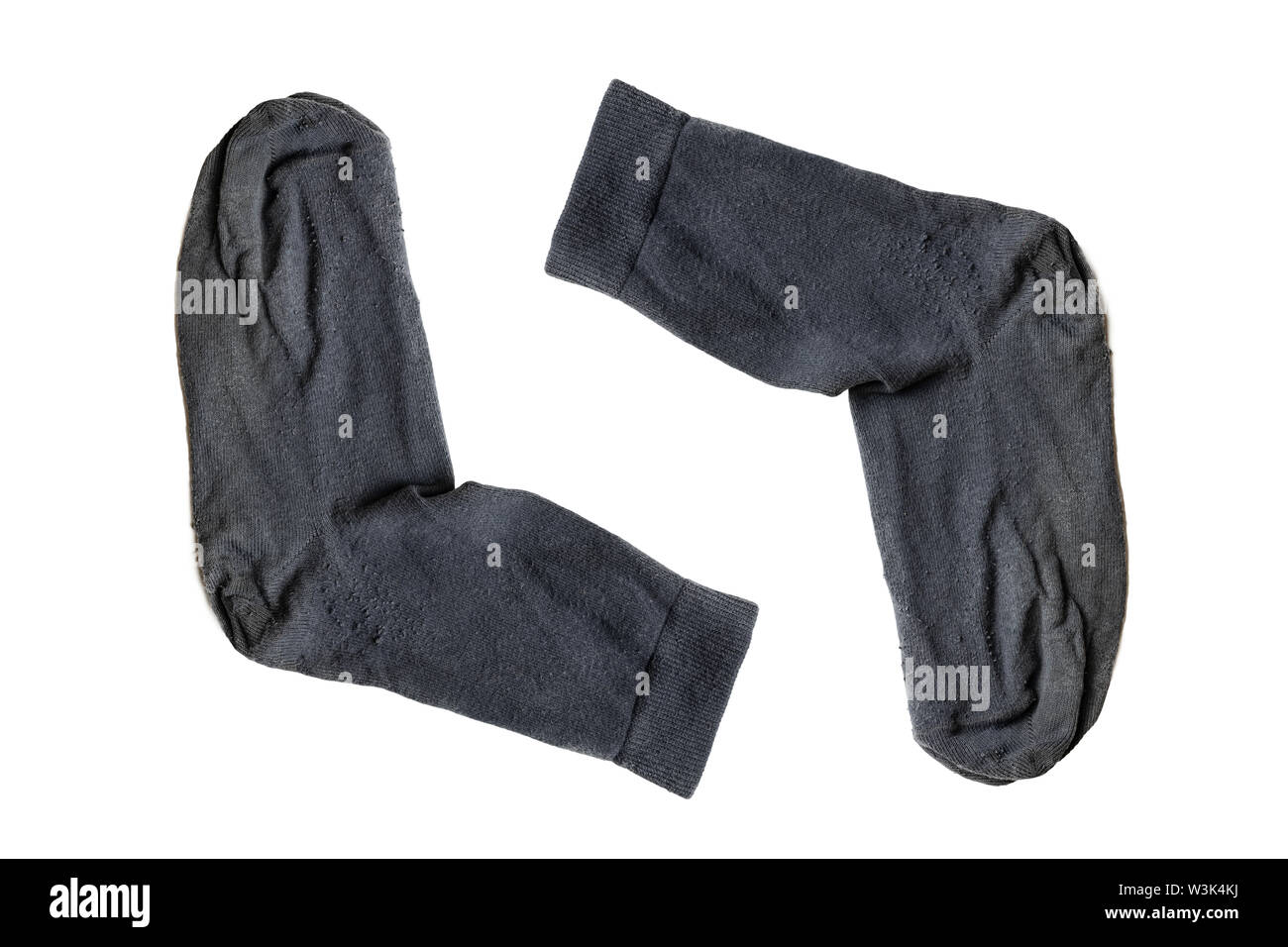 Old gray socks, isolated, close up. Two worn used dirty socks after ...