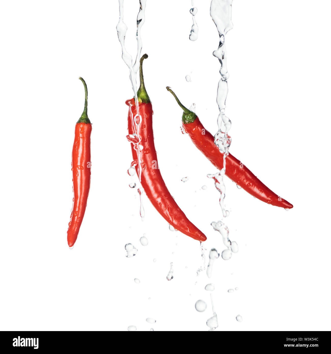 bright spicy red chili peppers with clear water streams isolated on ...