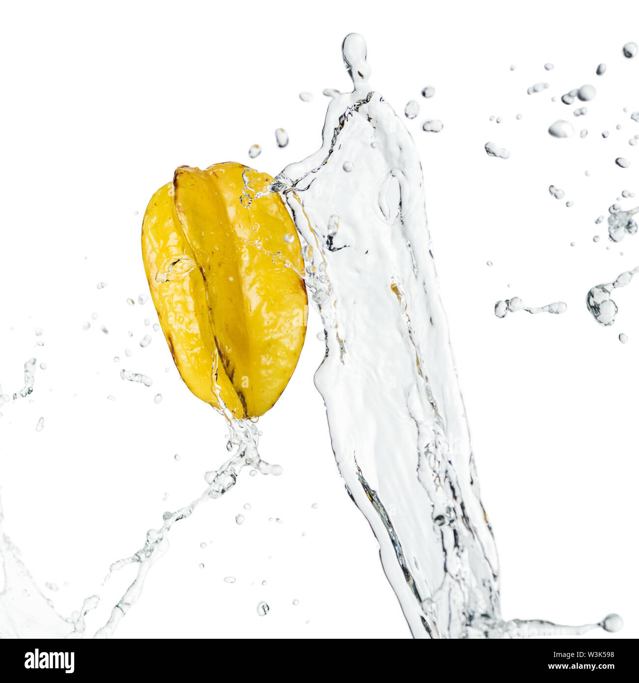 whole ripe exotic star fruit and clear water splash with drops isolated ...