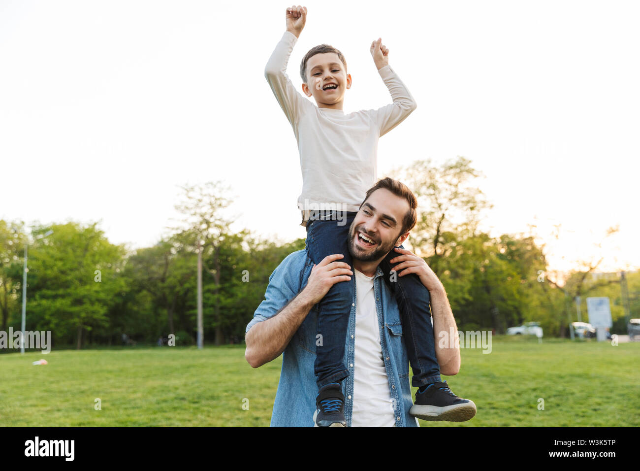Two happy brothers spending fun time at the park, piggyback ride Stock ...