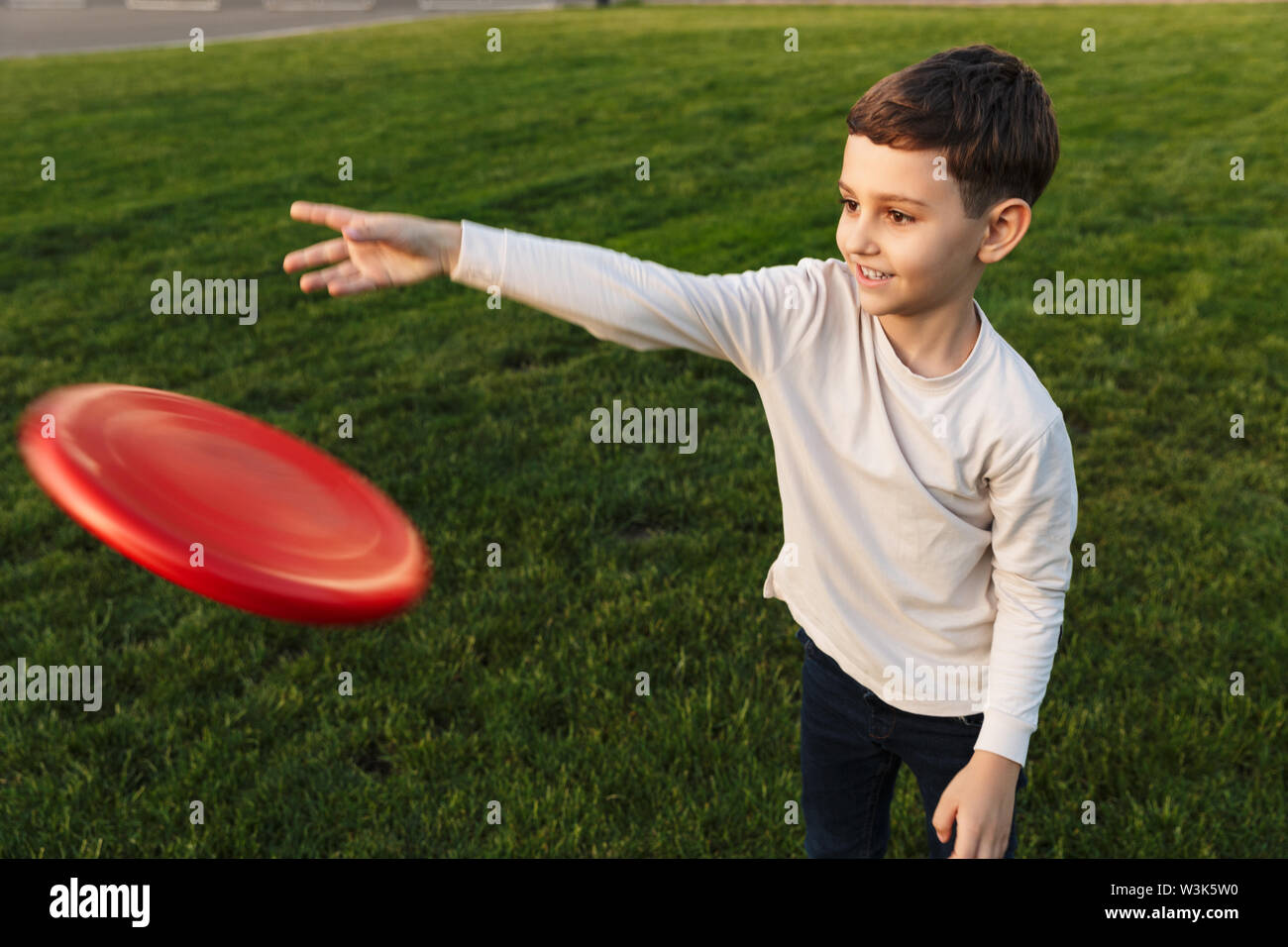 Close up of a happy little kid playing frisbee at the park Stock Photo ...