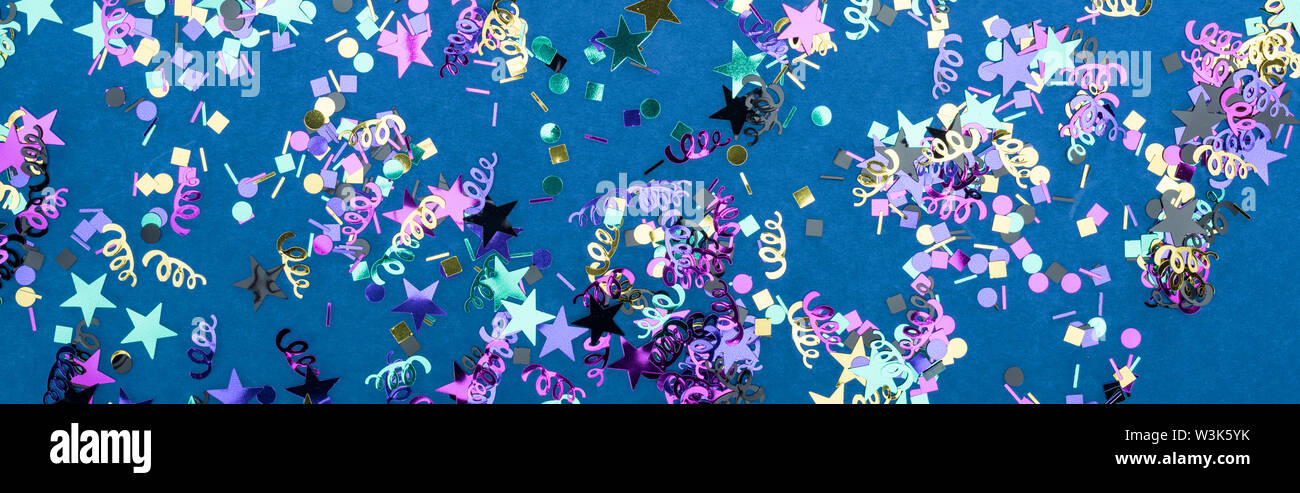 Panoramic shot of colorful confetti on blue party background Stock Photo - Alamy