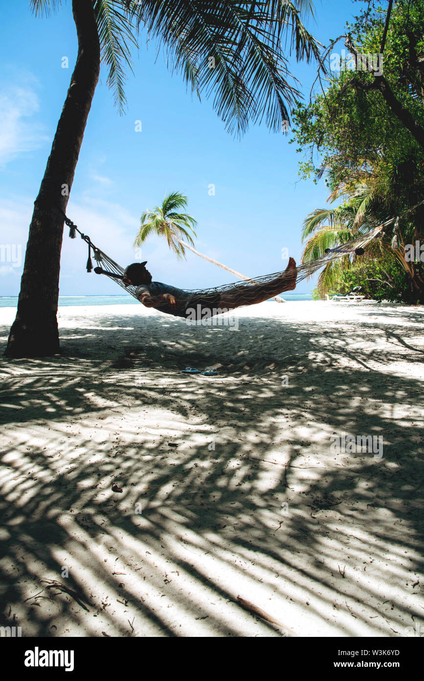 Young Man Relaxing In Hammock Stock Photo - Alamy