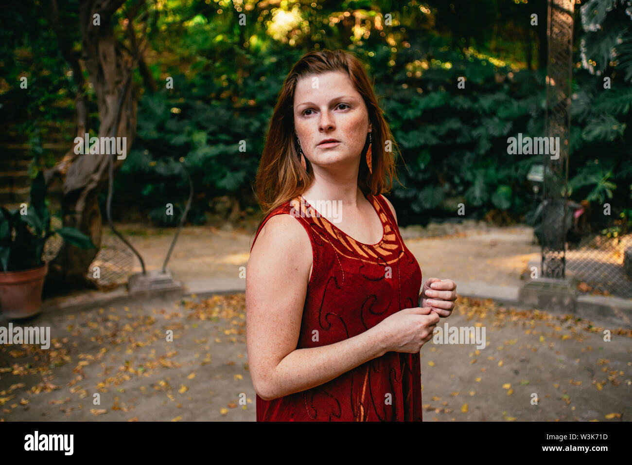 Serious attractive young woman looking back over her shoulder a she ...