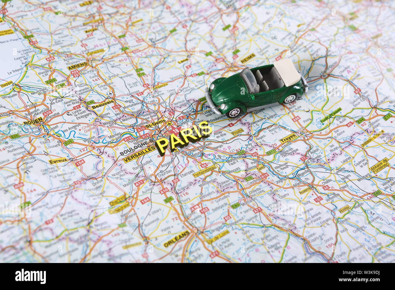 Wishing trip to Paris by car with road map Stock Photo - Alamy