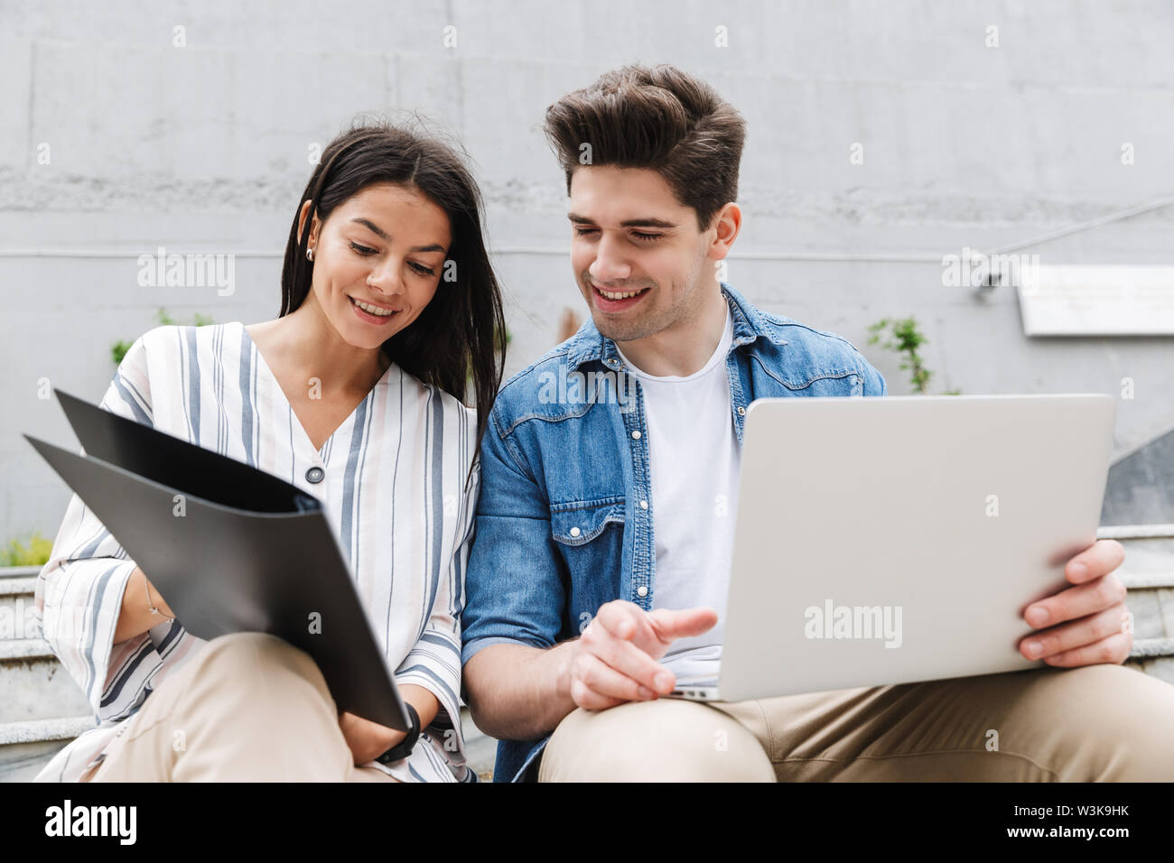 Image of happy young amazing loving couple business people colleagues ...