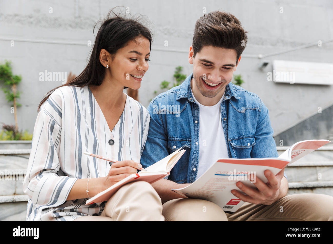 Photo of young amazing loving couple students colleagues outdoors ...